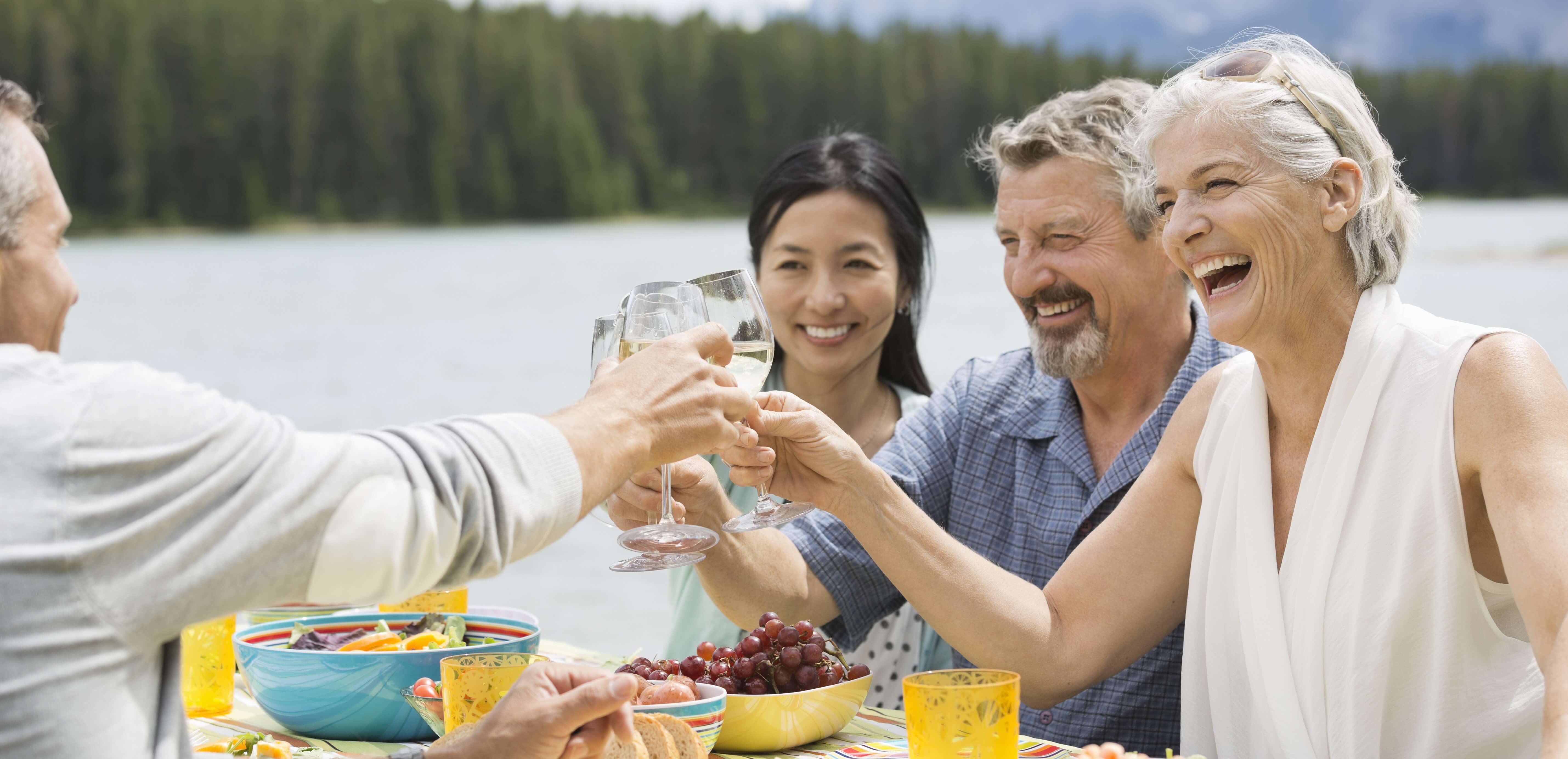 elderly-men-and-woman-laughing-over-meal-with-friends